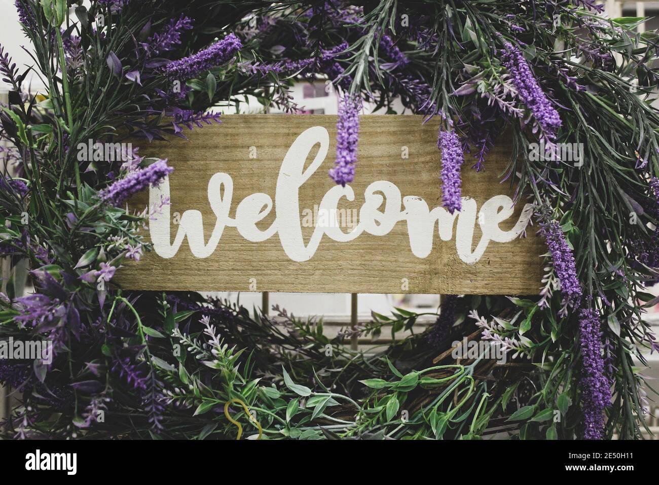 "welcome" signboard surrounded by a purple flower wreath Stock Photo ...