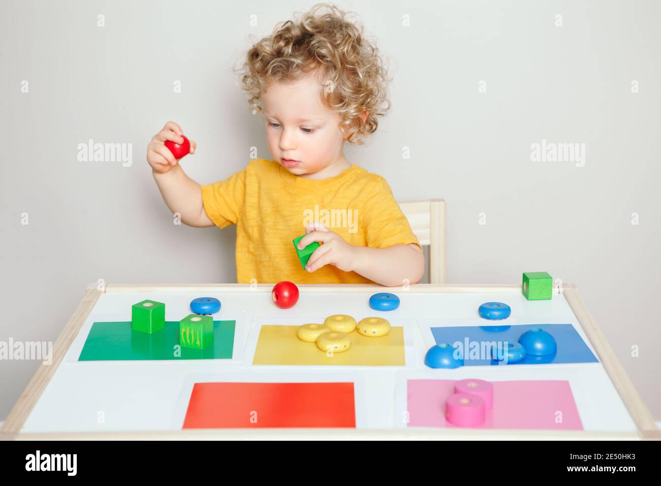Toddler playing with learning toys at home or kindergarten. Baby ...