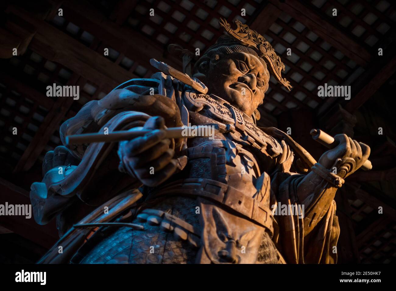 Close up from below of the huge wooden statue of the guardian deity ...