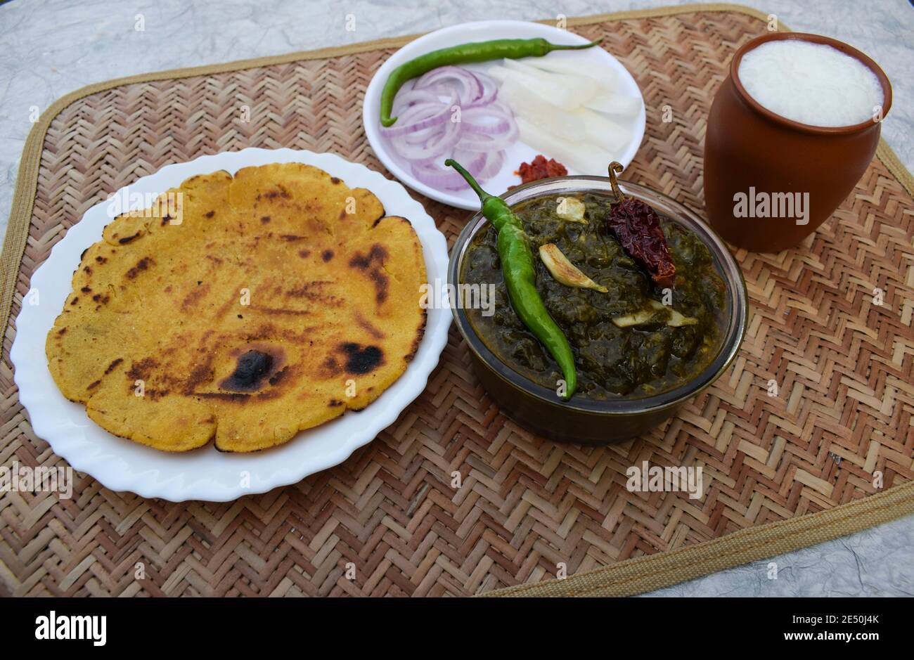 IndiaMakki roti and sarson saag with onion chilly salad and earthened ...