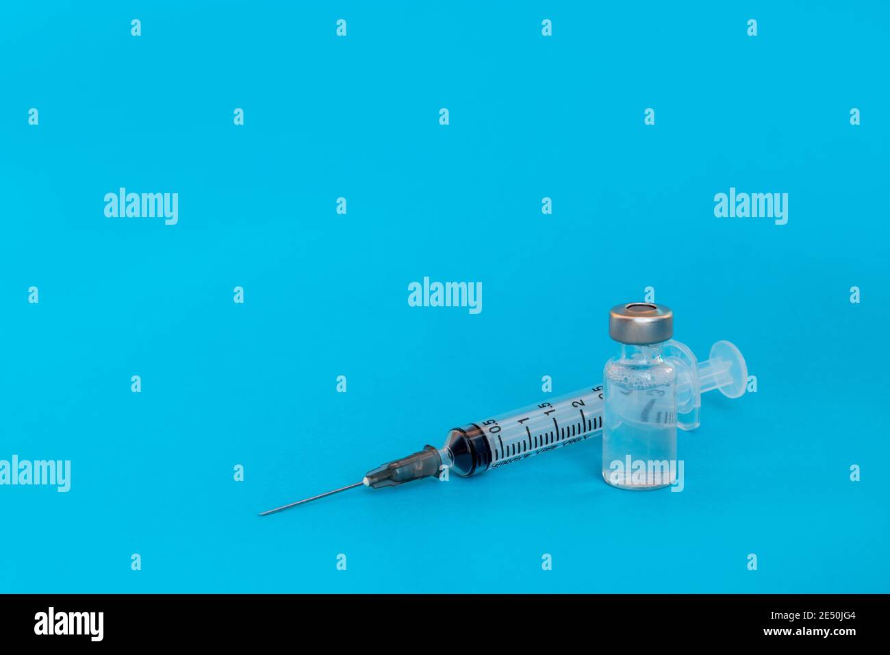 Medicine infectious concept. Vaccine and syringe injection on blue ...