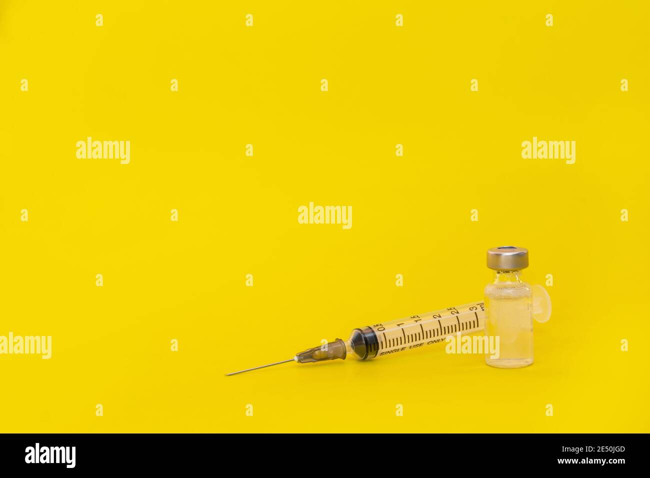 Medicine infectious concept. Vaccine and syringe injection on yellow ...