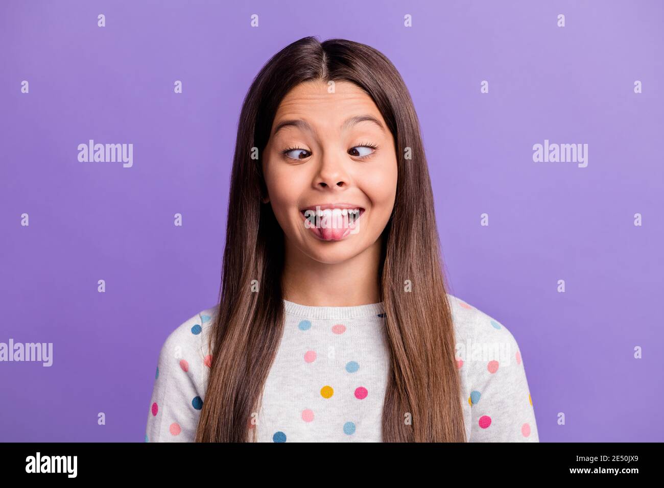 Photo portrait of goofy child showing tongue looking at nose isolated ...