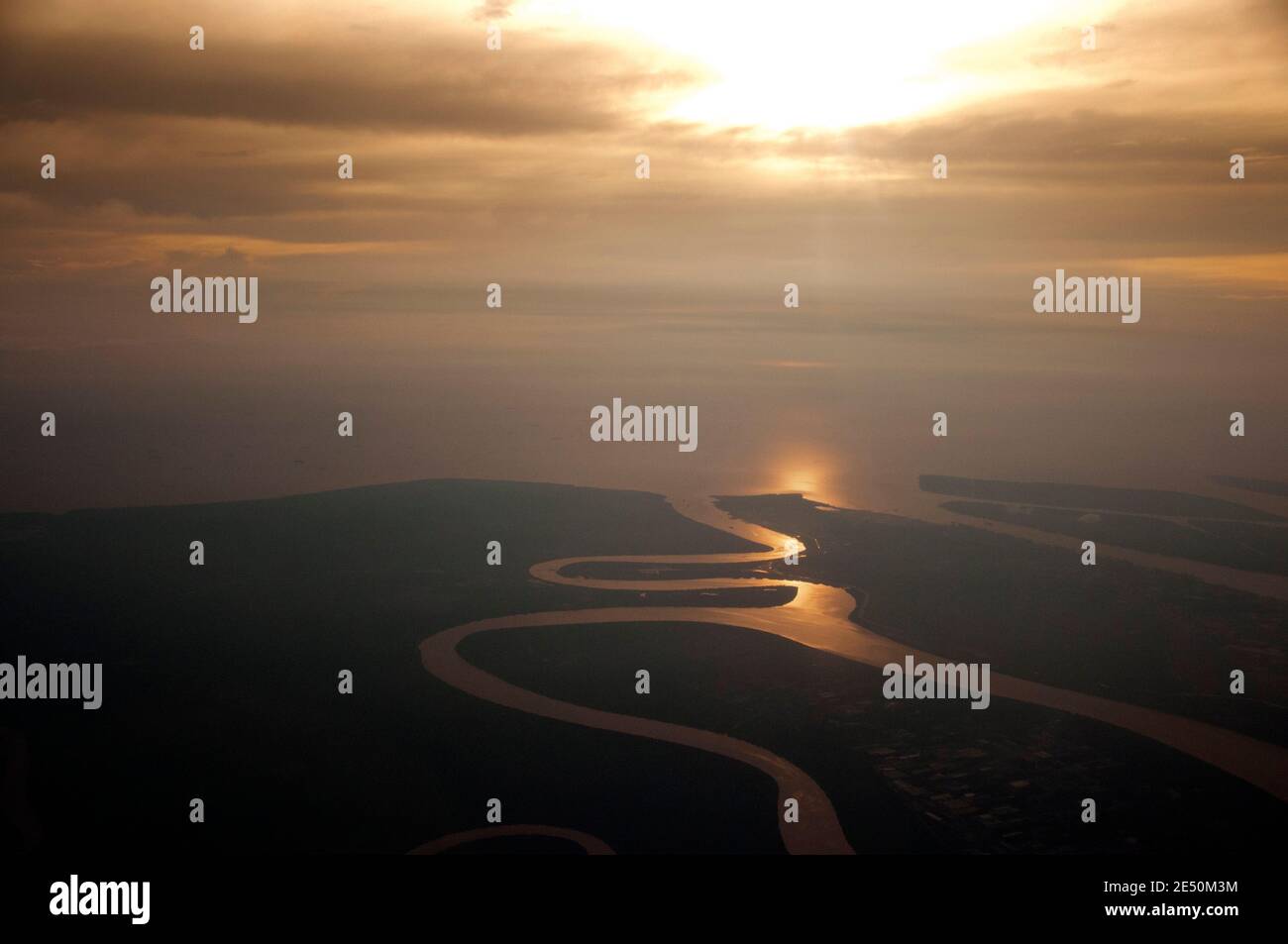Aerial view of the land below as seen from high altitude, with fluffy ...