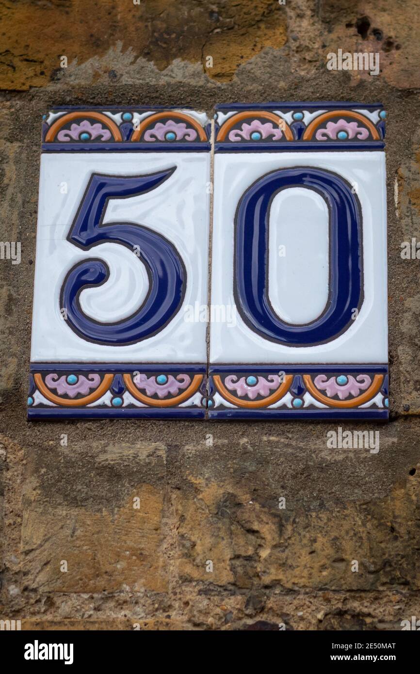 Number 50 in tiles on a brick wall Stock Photo - Alamy