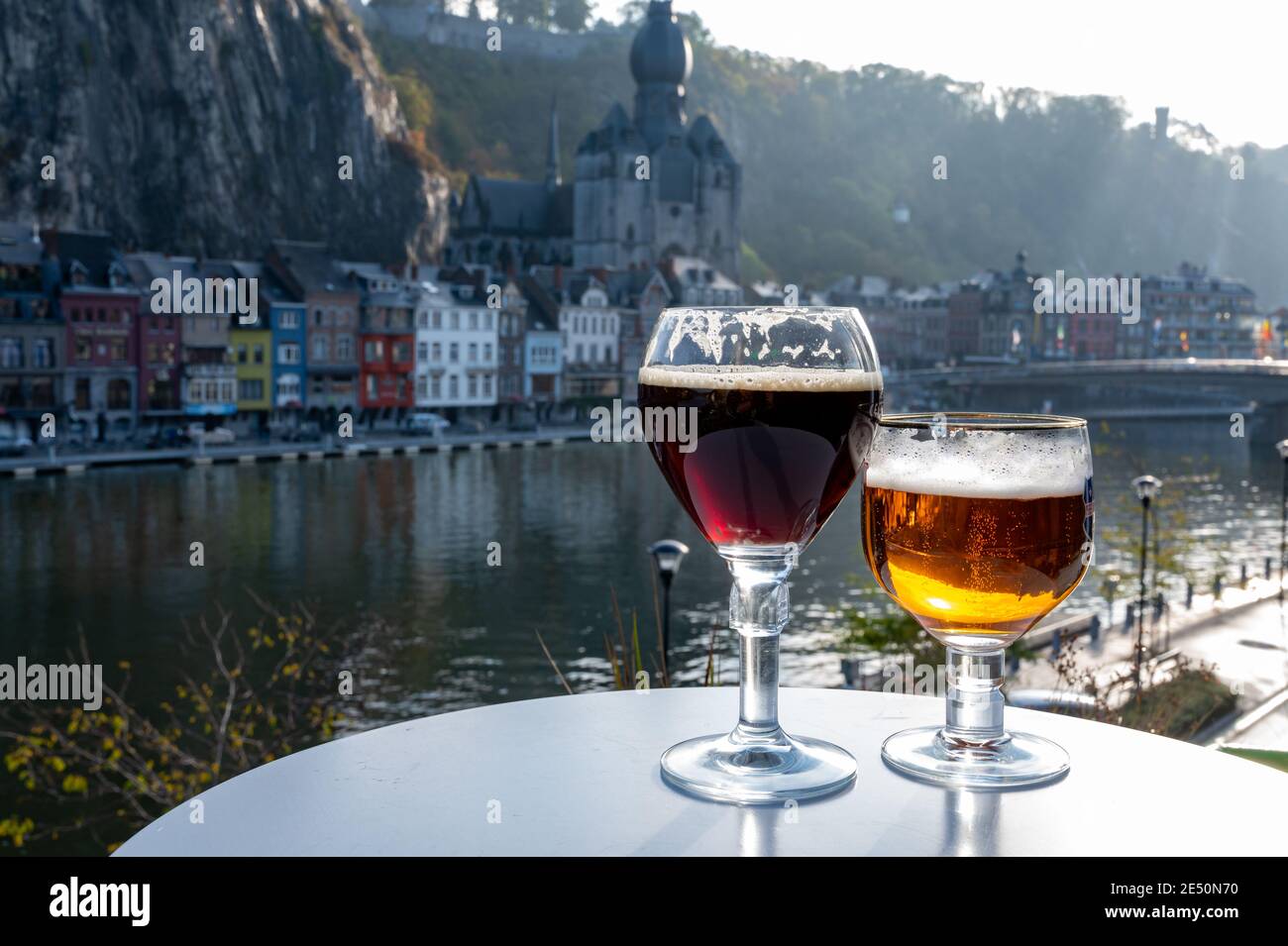 Drinking of dark and strong Belgian abbey beer with cheeses in sunny ...