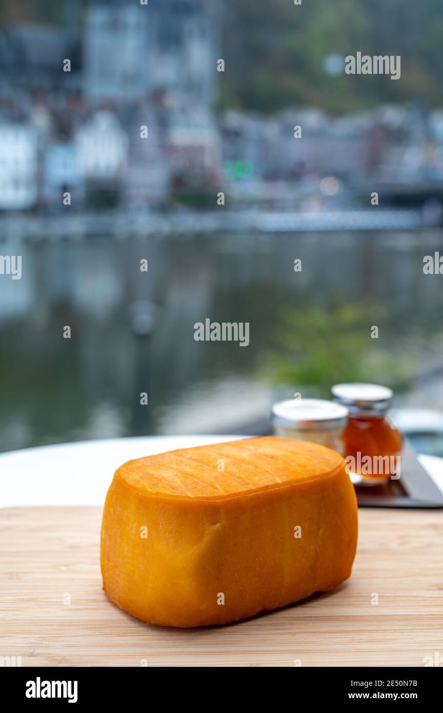 Block of Belgian abbey cheese made with brown trappist beer and view on ...
