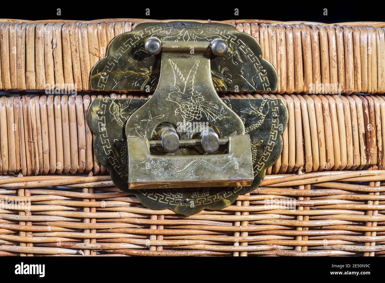 brass Chinese trunk lock with dragon and bird on a wicker chest Stock ...