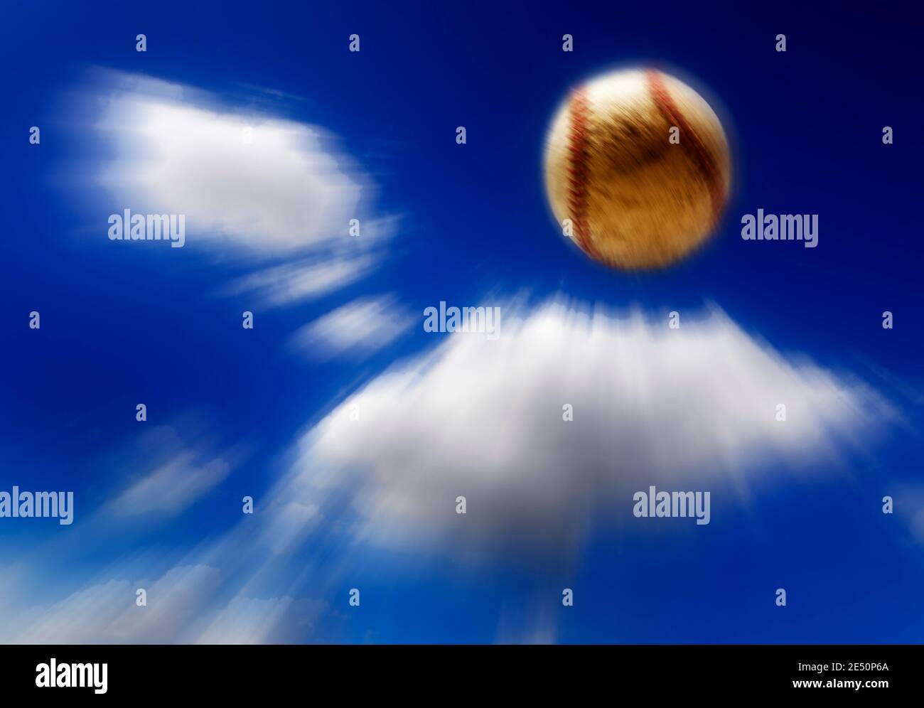 Baseball flying through the air with clouds and sky in background ...