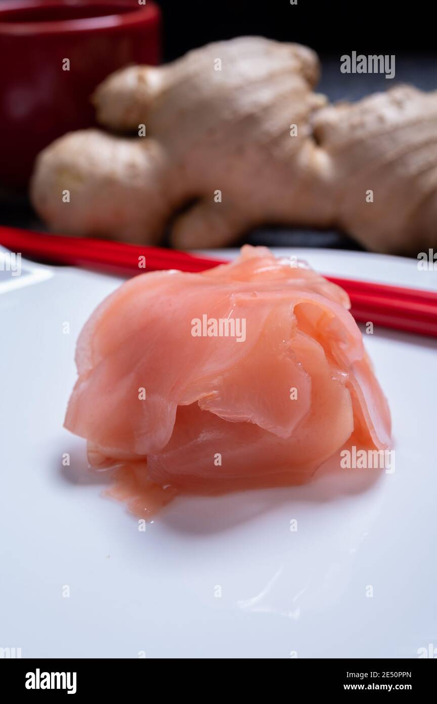 Asian food, pink sliced pickled ginger roots ready to eat, close up ...