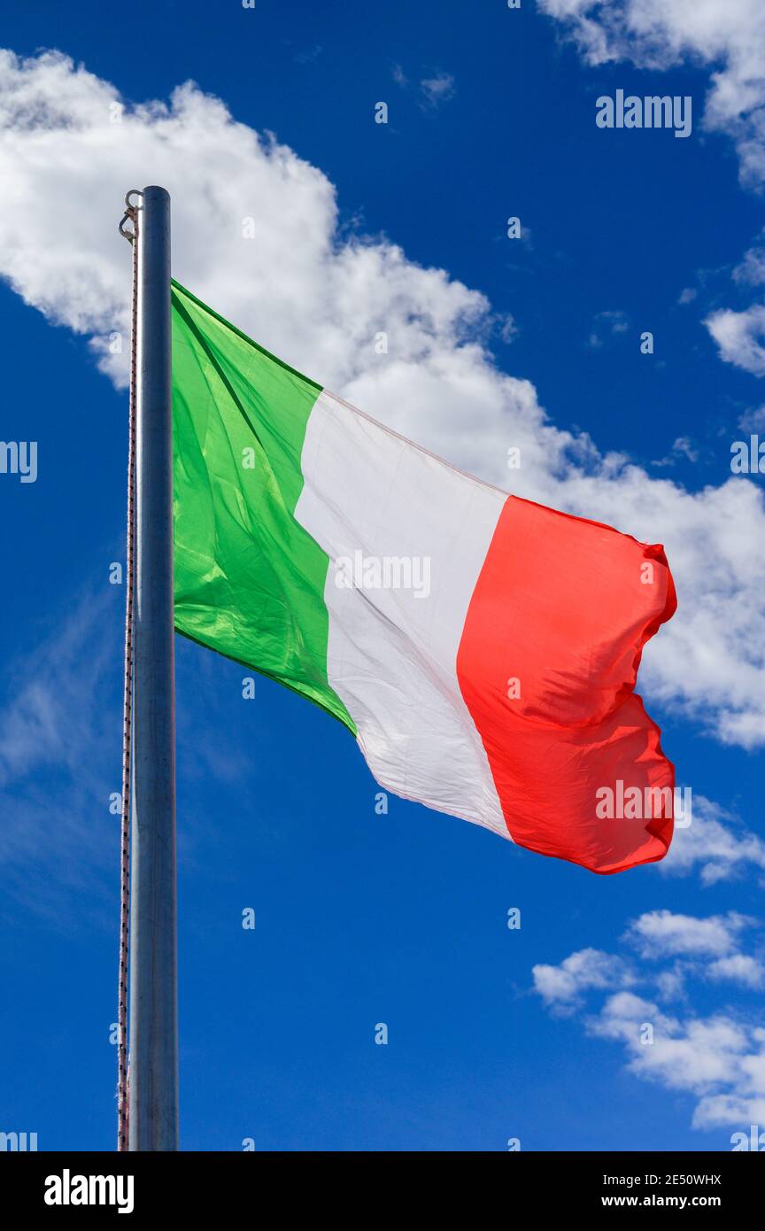 Green-white-red national italian flag waving on mast in sunny day Stock ...