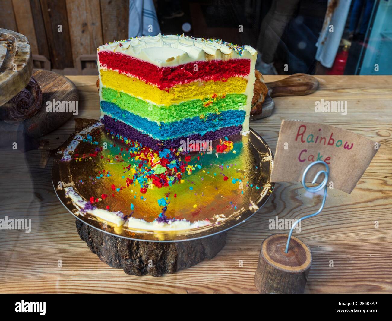 Rainbow Cake for sale in the window of a cafe bakery in London's Brick ...