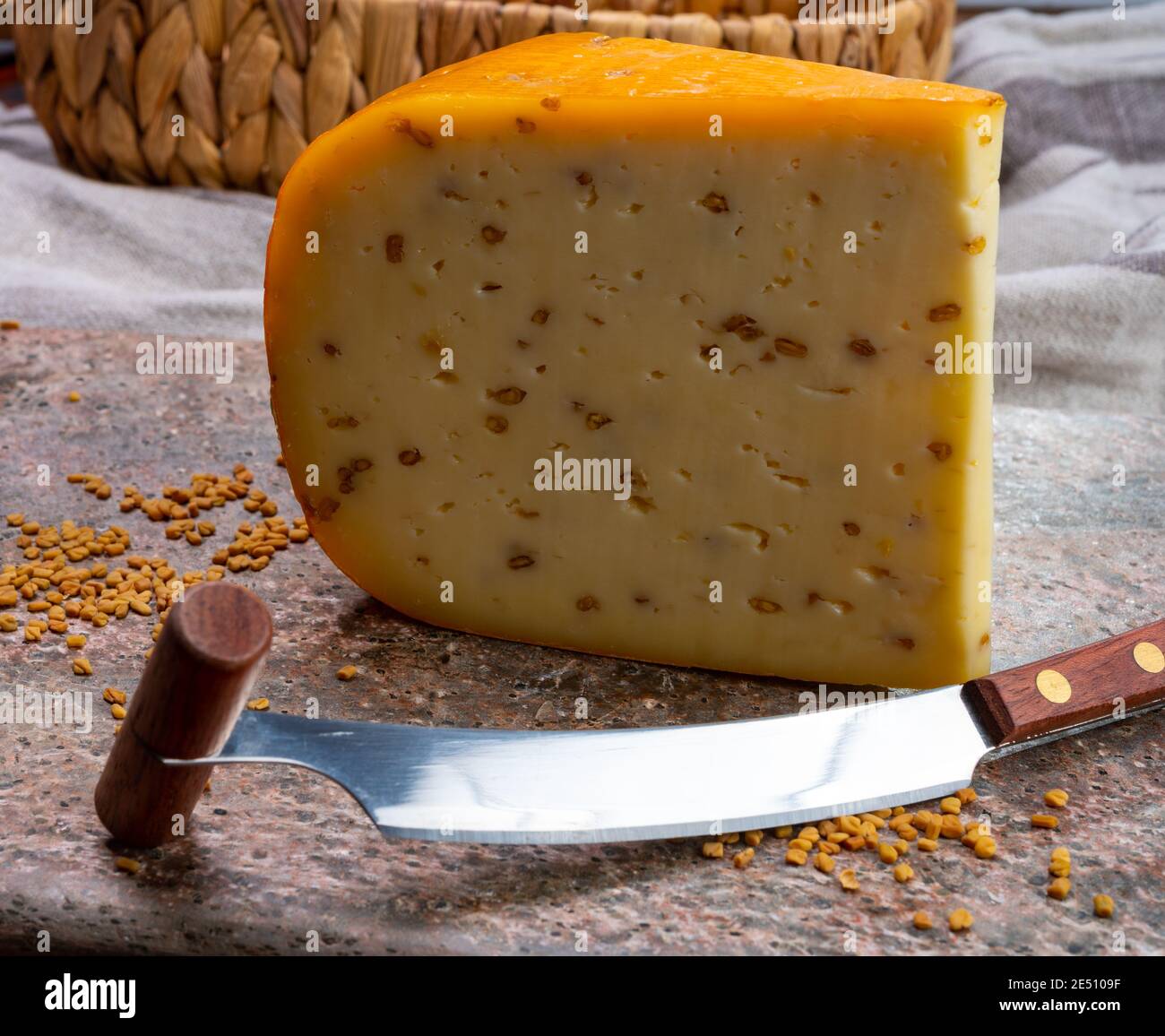 Cheese collection, piece of hard yellow Dutch gouda cheese with dried ...