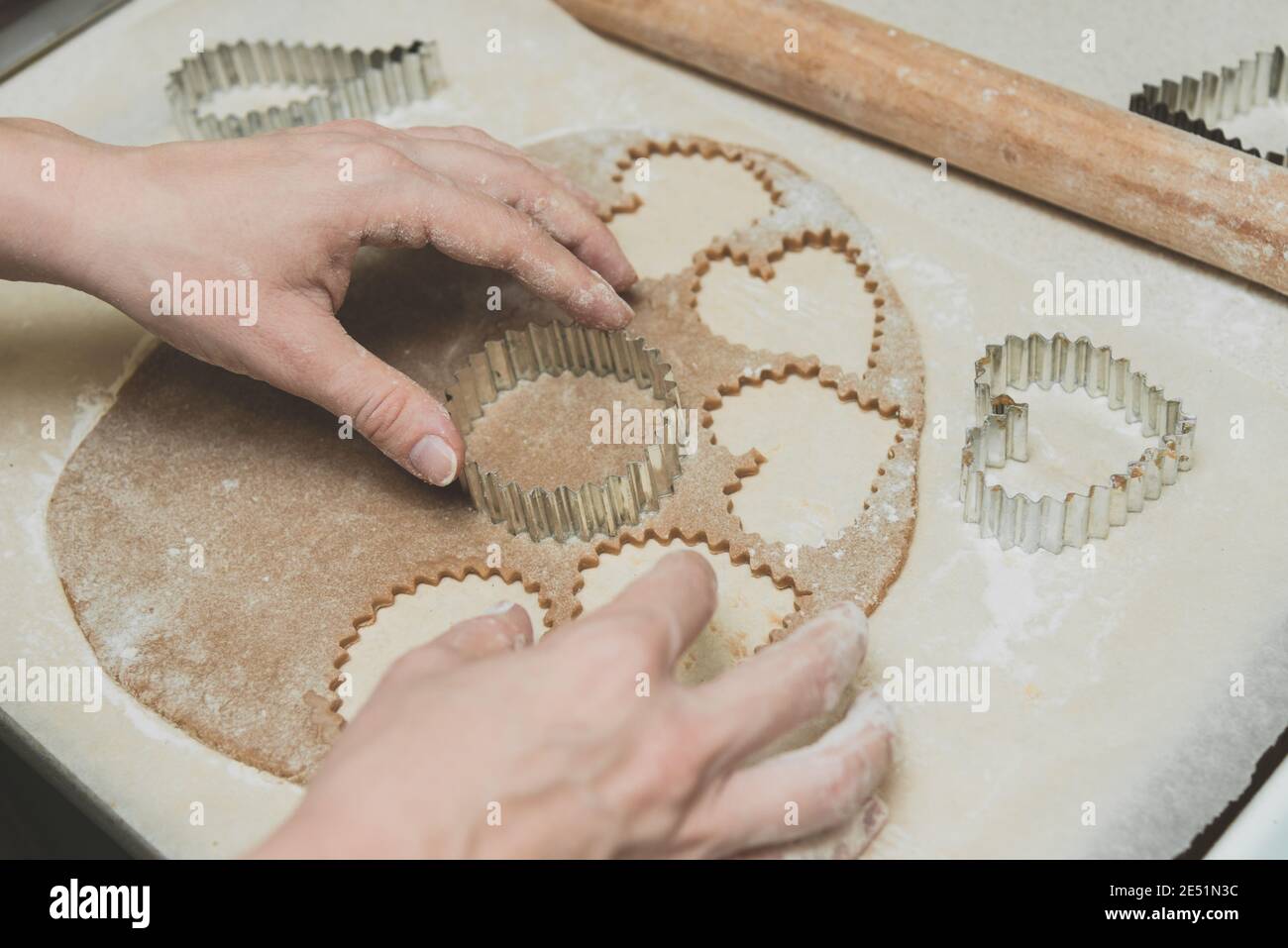 Process of cutting cookies by cookie cutters. Woman making by hands ...