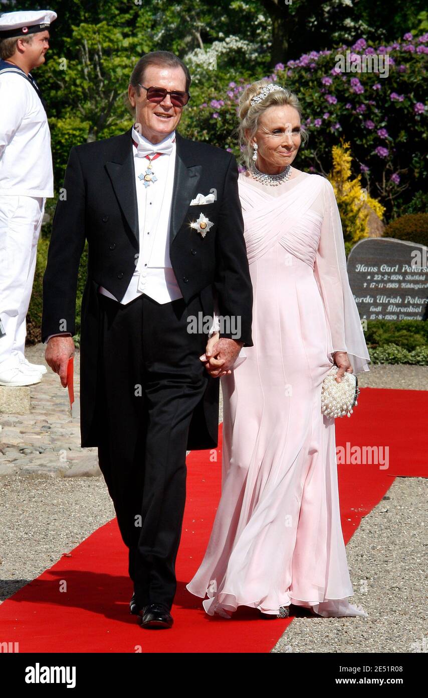 Sir Roger Moore and his wife Christina 'Kiki' Tholstrup arrive to ...