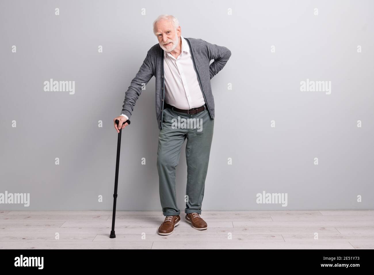 Full size profile photo of old sad man touch back stand with wand wear ...