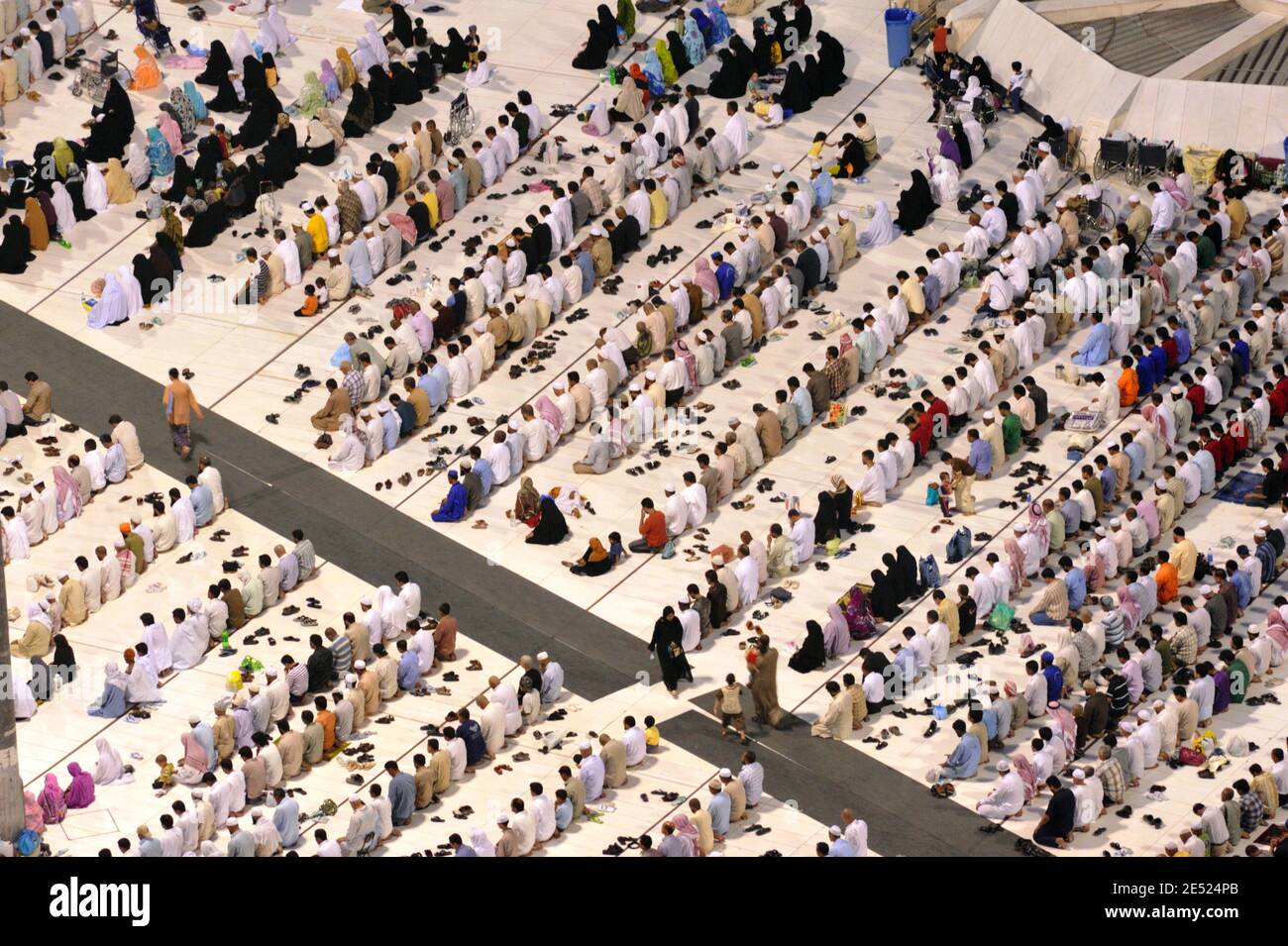 Prayers are seen next to the Great Mosque surrounding the 'kaaba', or ...