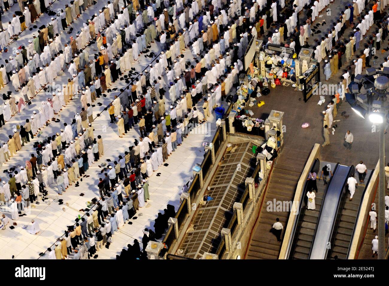 Prayers are seen next to the Great Mosque surrounding the 'kaaba', or ...