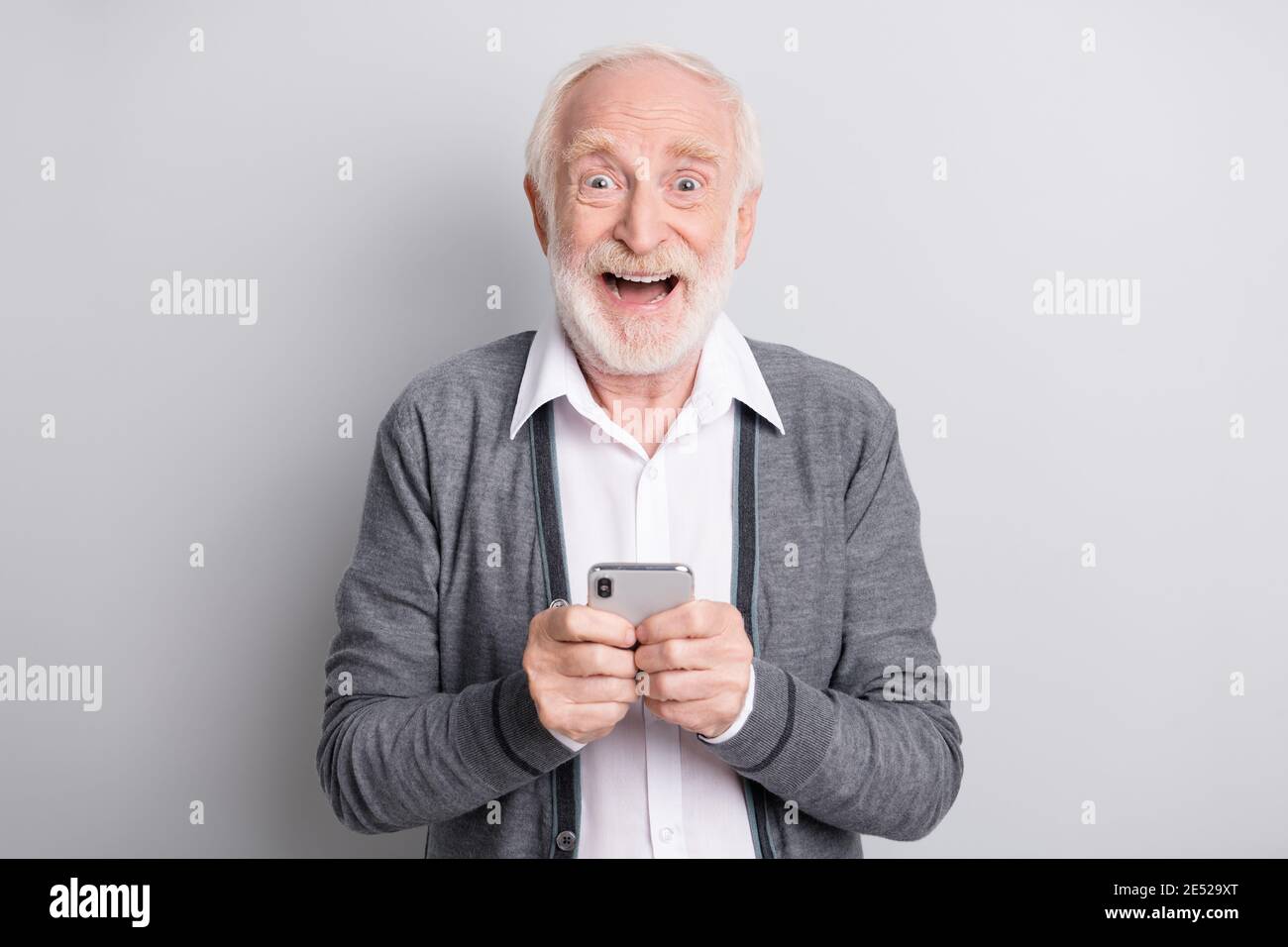 Portrait of old white hair hooray man hold telephone wear dark sweater ...