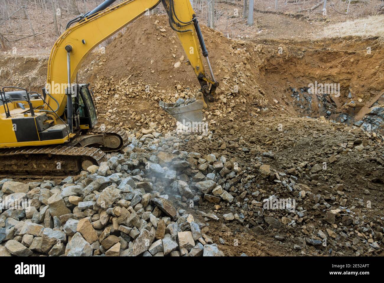 Excavator unload gravel loader with a bucket filled with crushed stone ...