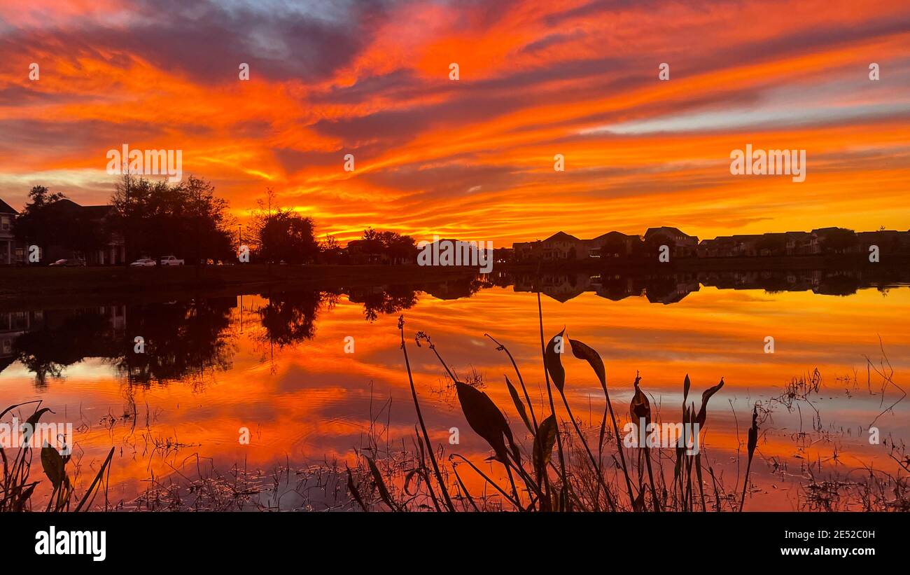 Beautiful pink, orange and blue sunset reflecting on a lake in a ...