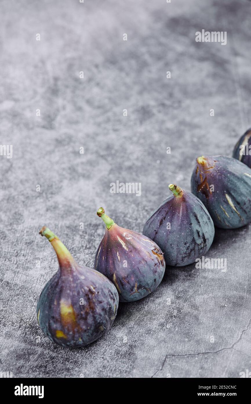 Purple ripe figs on a marble background Stock Photo - Alamy