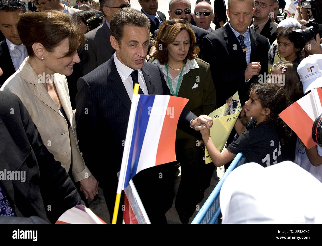 French President Nicolas Sarkozy, his wife Carla Bruni-Sarkozy shake ...