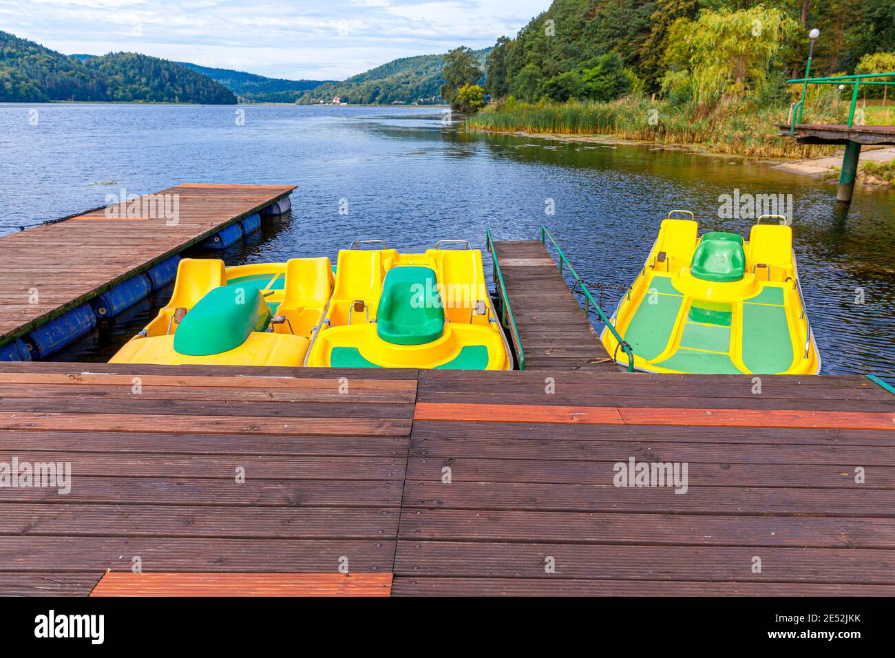 Pedal boats or paddle boats catamarans station. Yellow water bicycles ...