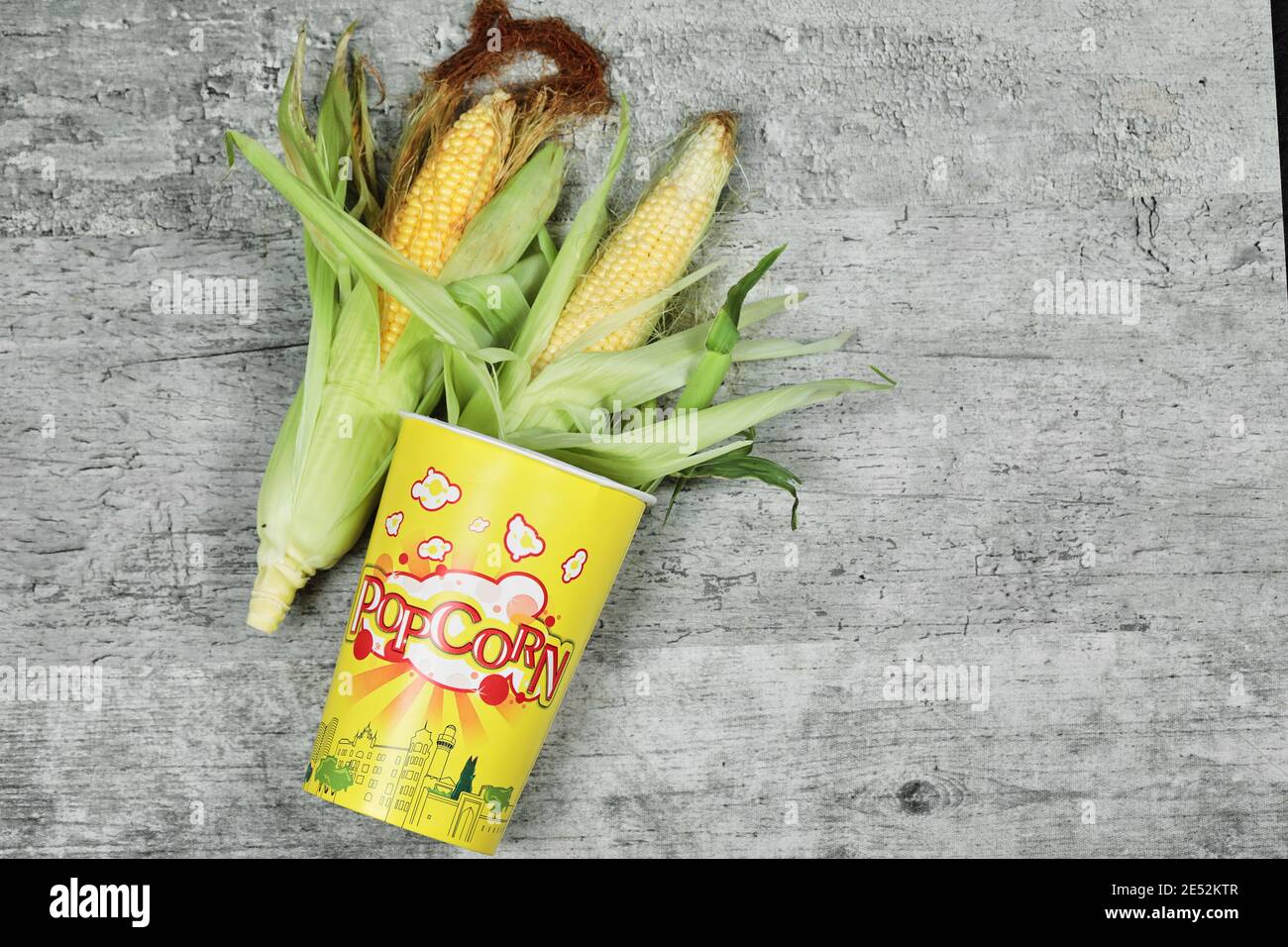 Fresh corns in paper container on stone background Stock Photo - Alamy