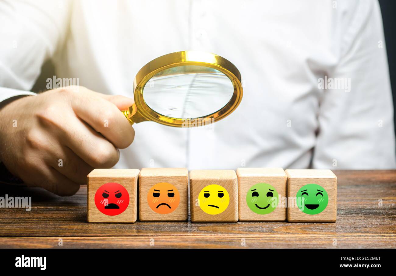 The man studies blocks with mood symbols from happily satisfied to ...