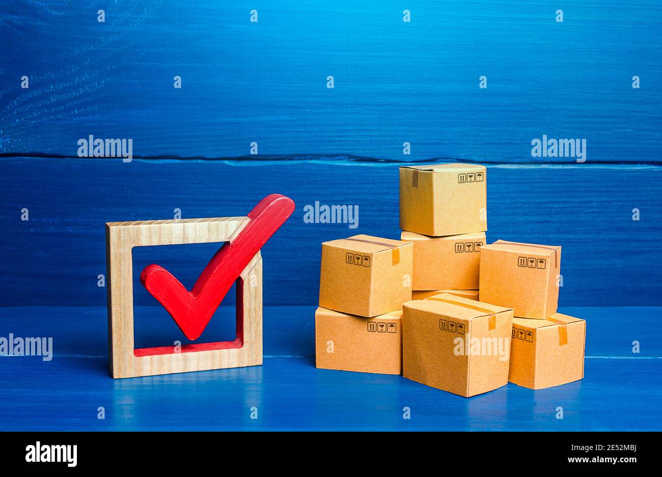 Boxes and red check mark. Verification and standardization of goods and ...