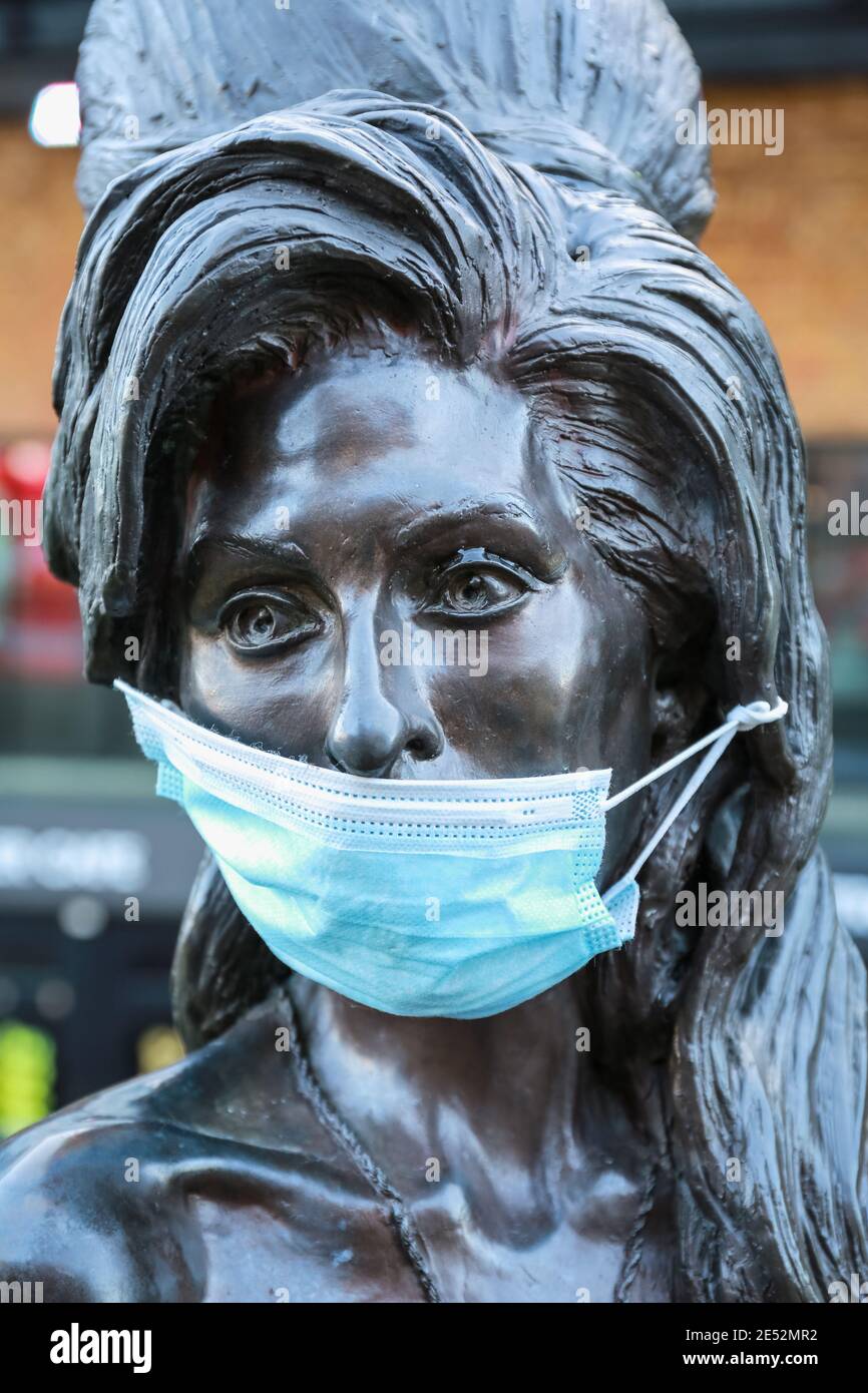 London, UK. 25 January 2021. Amy Winehouse sculpture is wearing a face ...