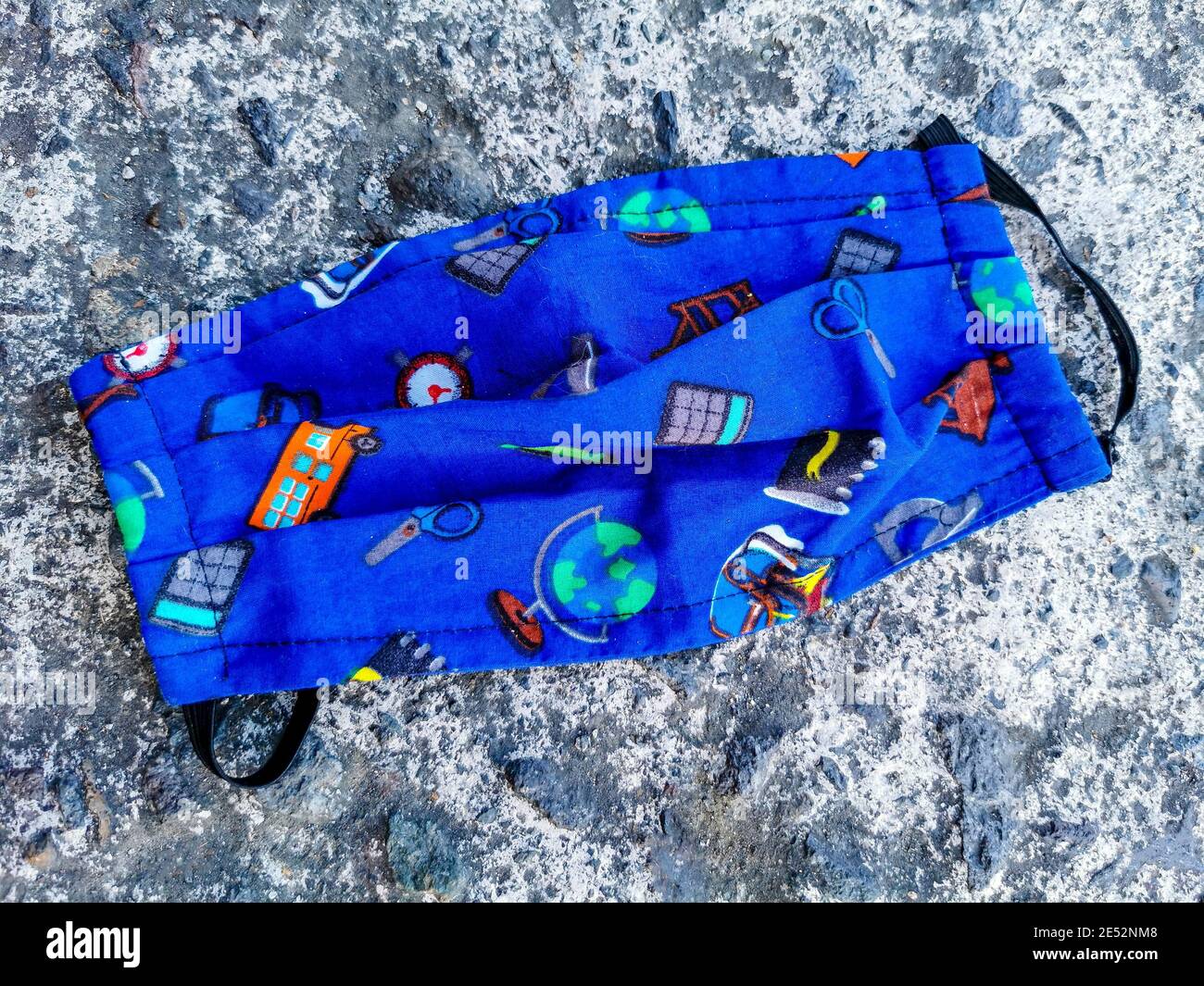 Colorful blue childrens face masks on the ground. Corona virus ...