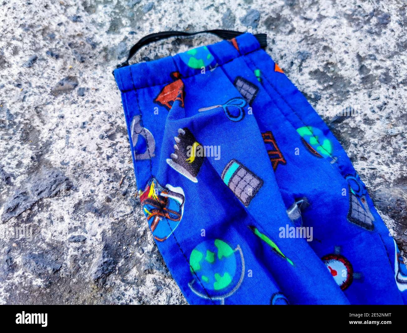 Colorful blue childrens face masks on the ground. Corona virus ...