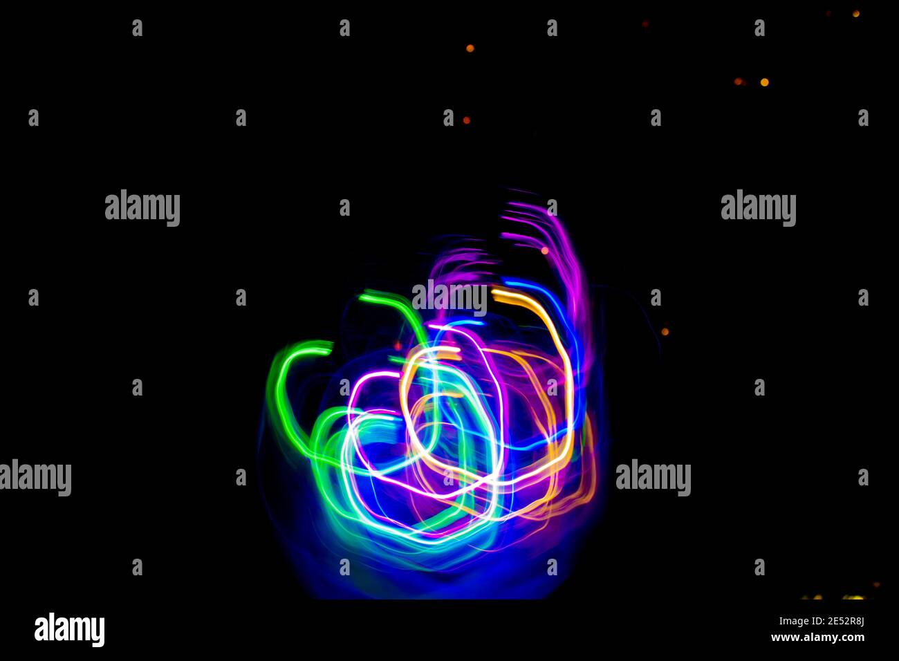 Neon color light tracks against night sky with bokeh lights Stock Photo ...