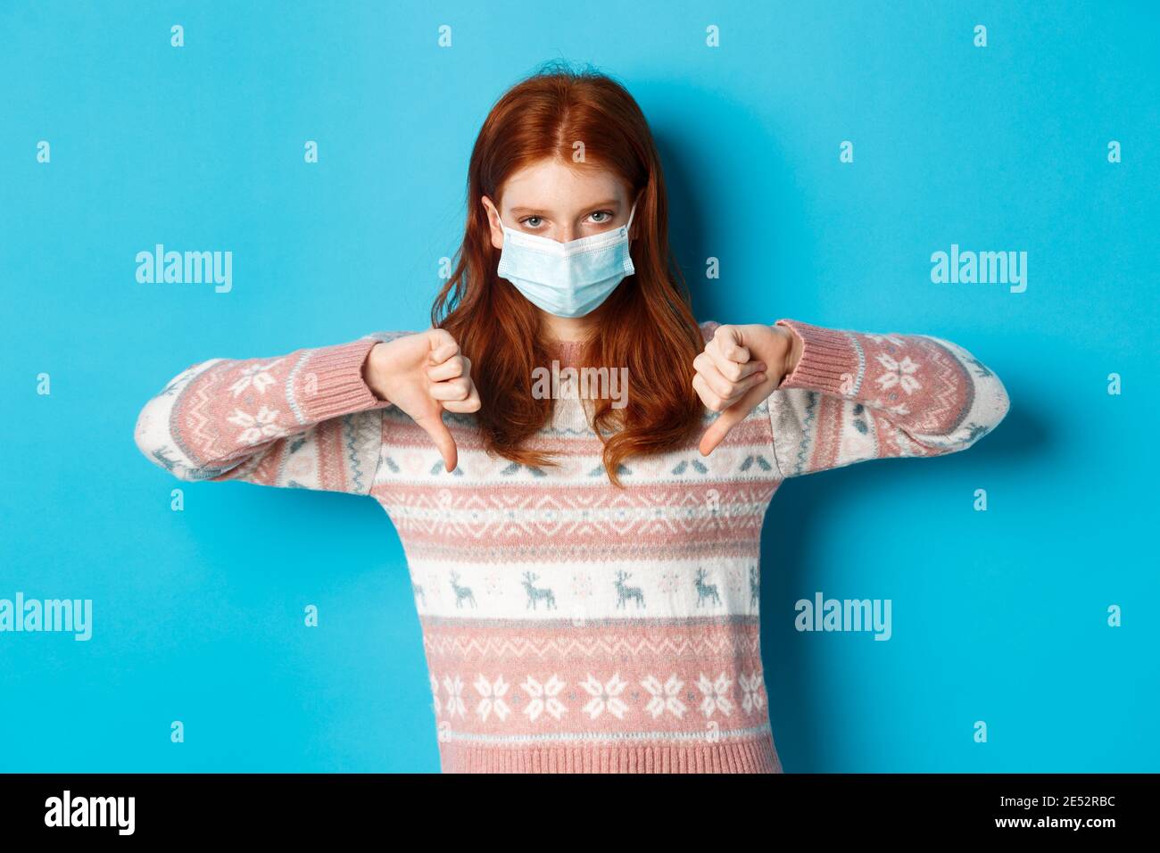 Winter, covid-19 and pandemic concept. Upset and angry redhead girl in ...