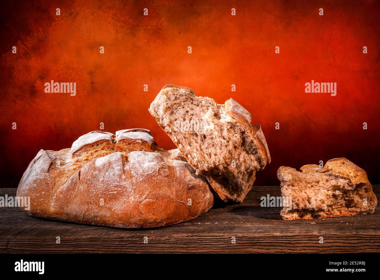 Country bread with floured crust with pieces of crumb on a barn wood ...