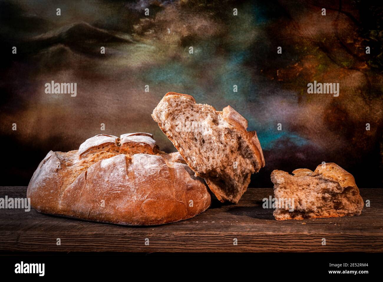 Country bread with floured crust with pieces of crumb on a barn wood ...