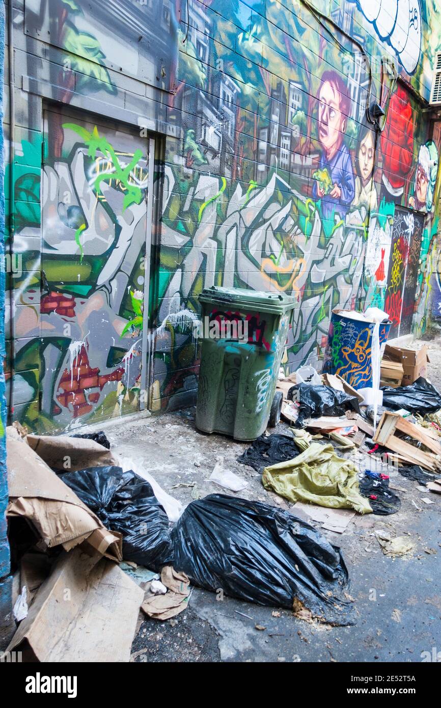 Garbage in graffiti alley featuring a large number of colourful wall ...