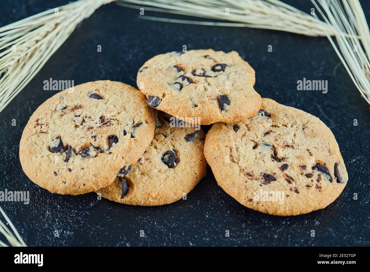 Chocolate chips cookies on a marble background with ears of wheat Stock ...