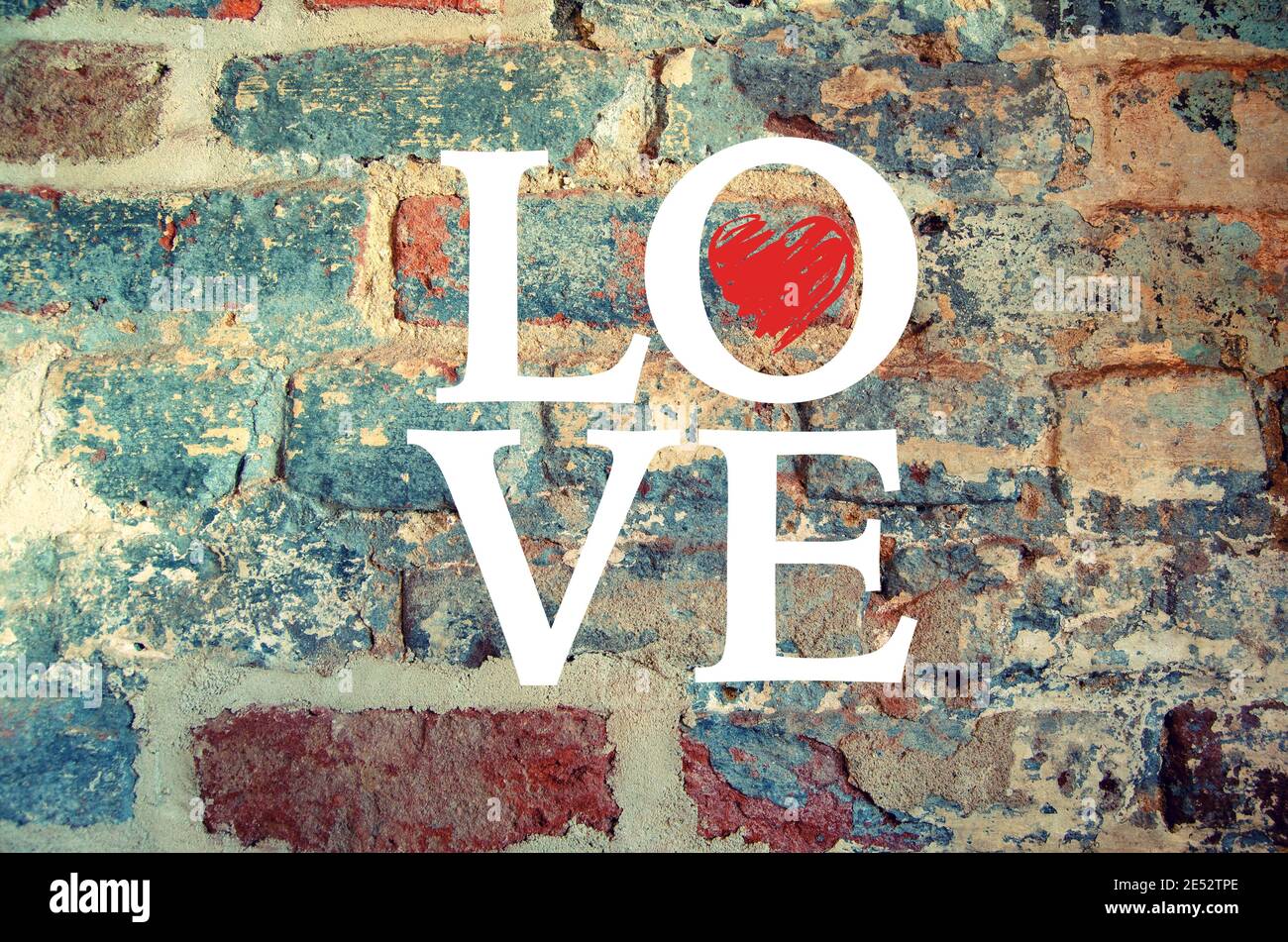 The word Love written against a brick wall background Stock Photo - Alamy