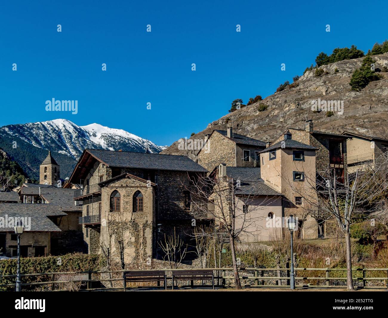 Medieval buildings set against the Pyrenese mountains in the parish ...