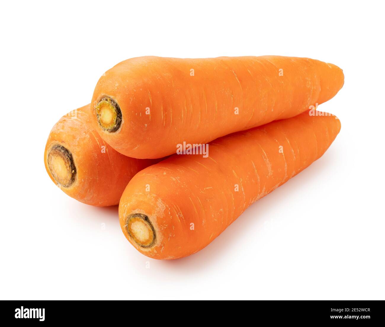 Three carrots on a white background Stock Photo - Alamy