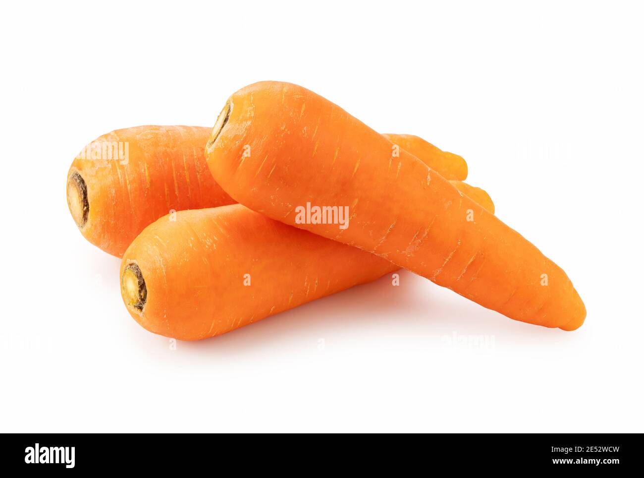 Three carrots on a white background Stock Photo - Alamy