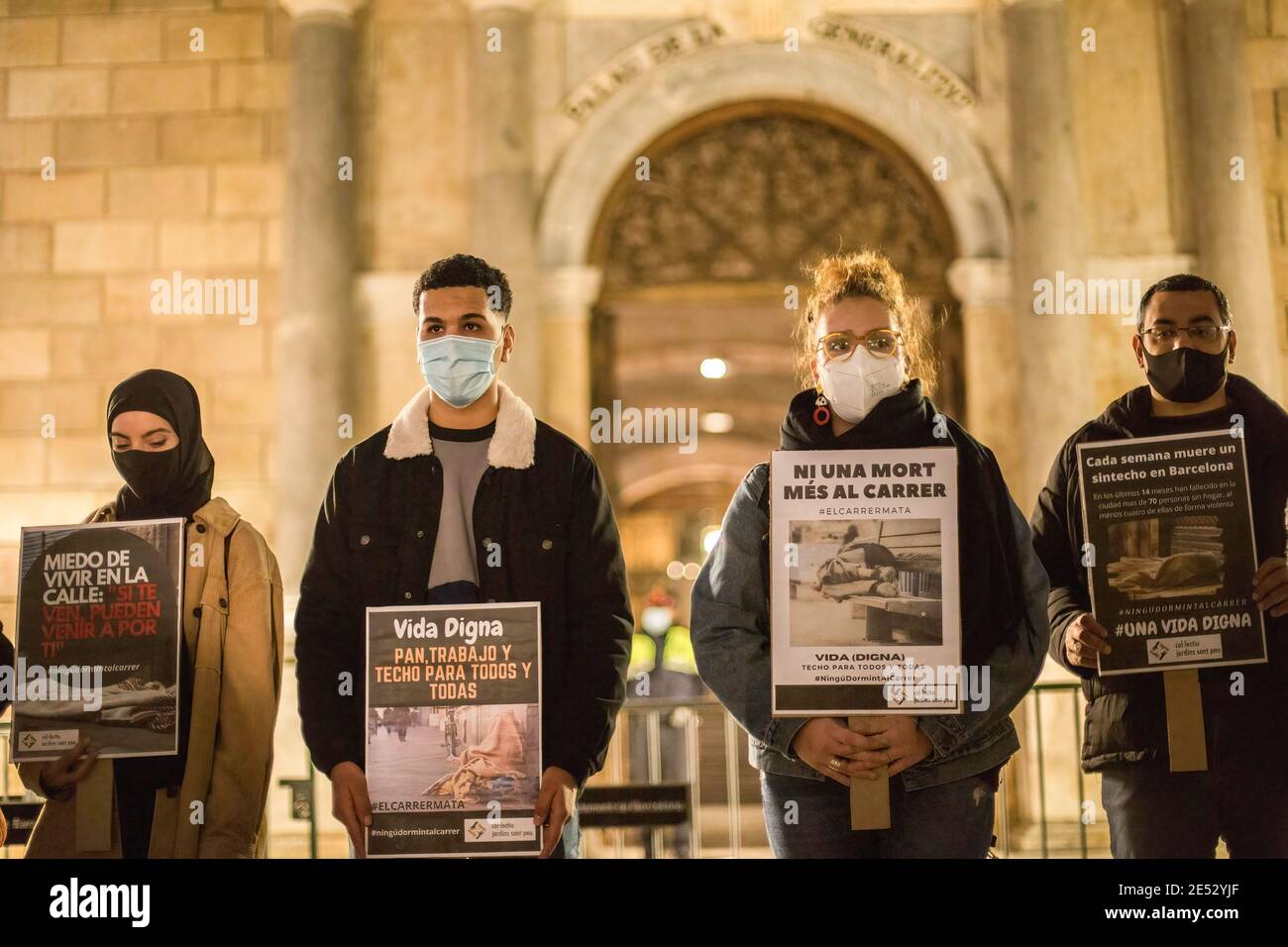 Protesters wearing face masks hold placards during the demonstration ...
