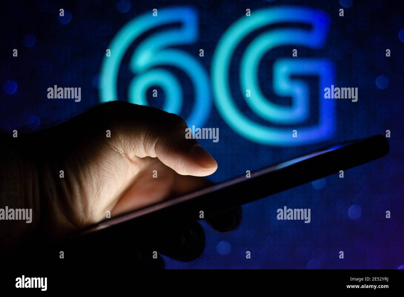 In this photo illustration, a person holds a mobile phone with a 6G ...