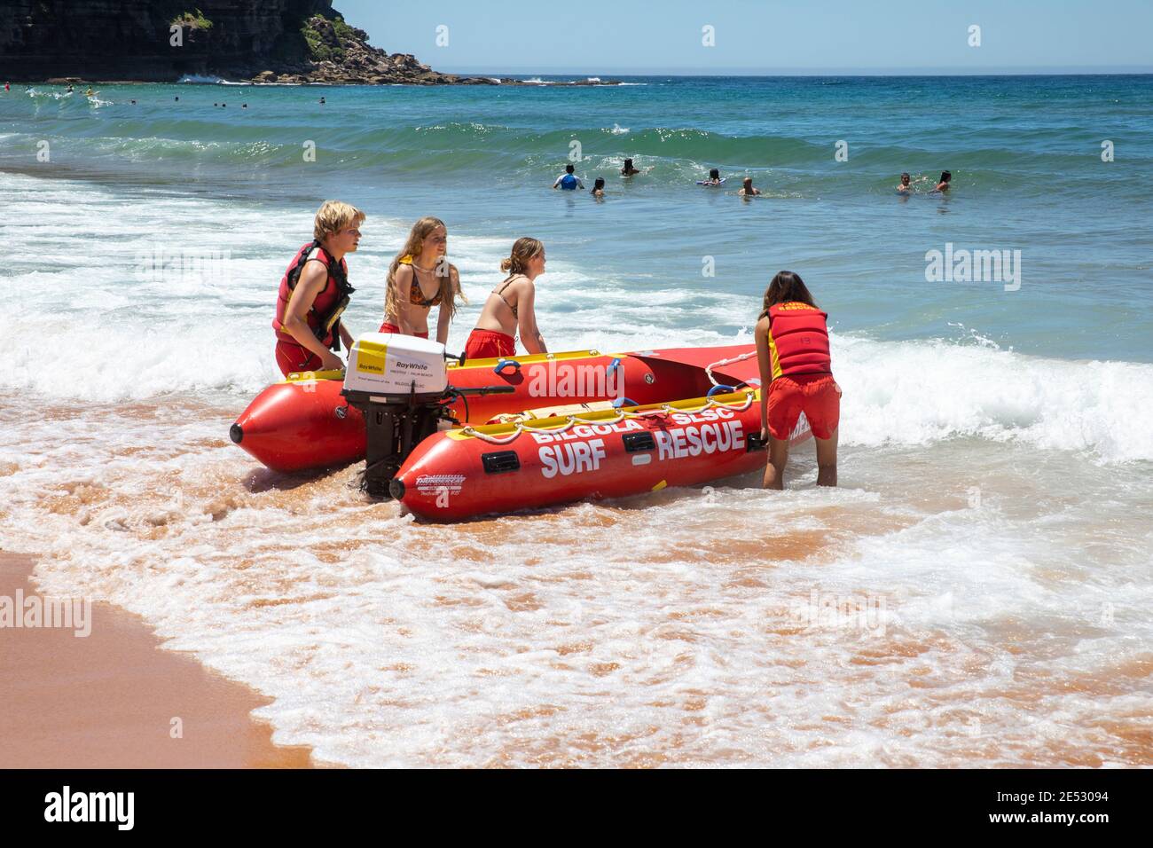 Volunteer surf rescue lifesavers launch inflatable red zodiac surf ...