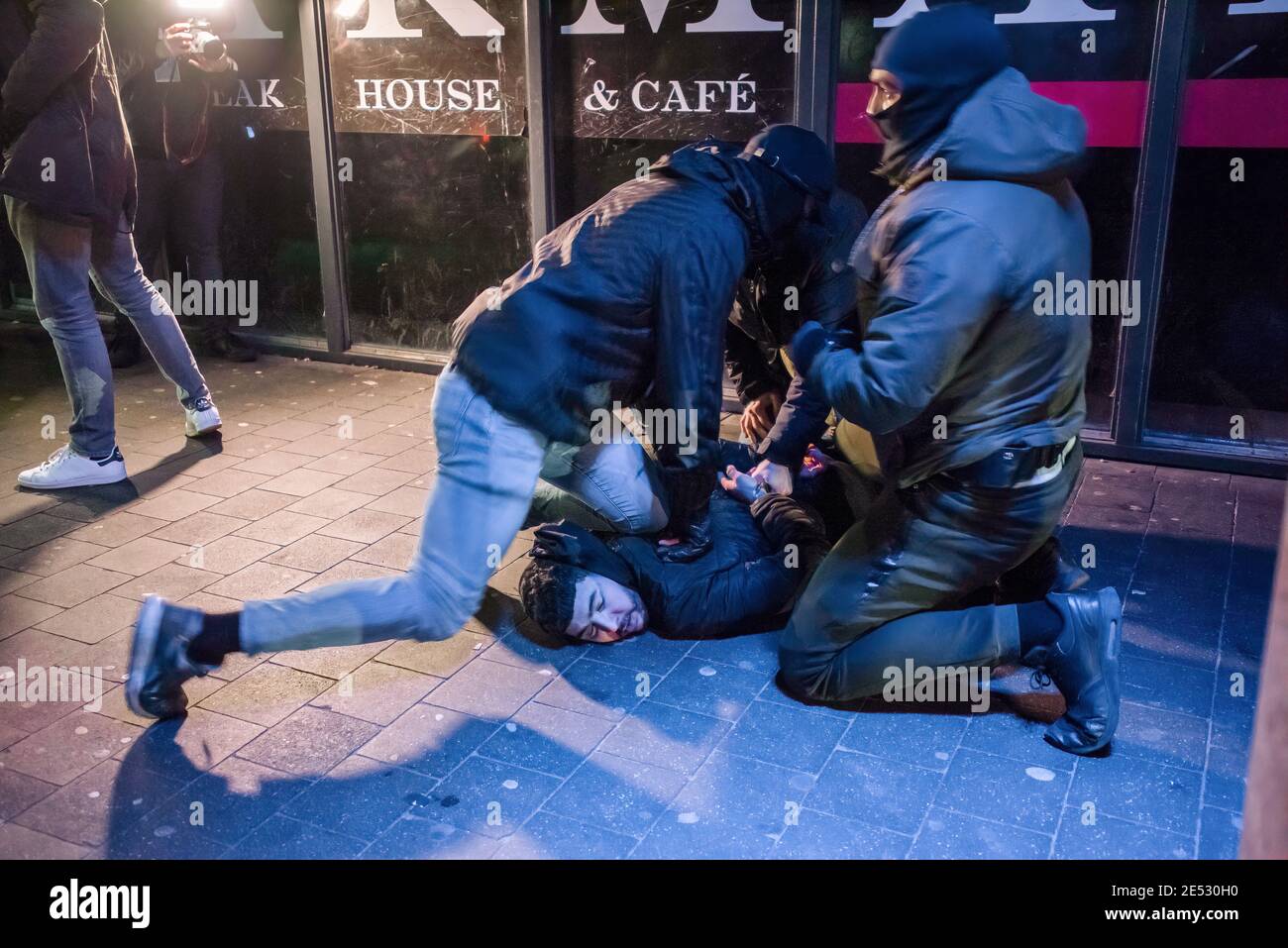 A protester is being arrested by undercover police officers.Riot police ...
