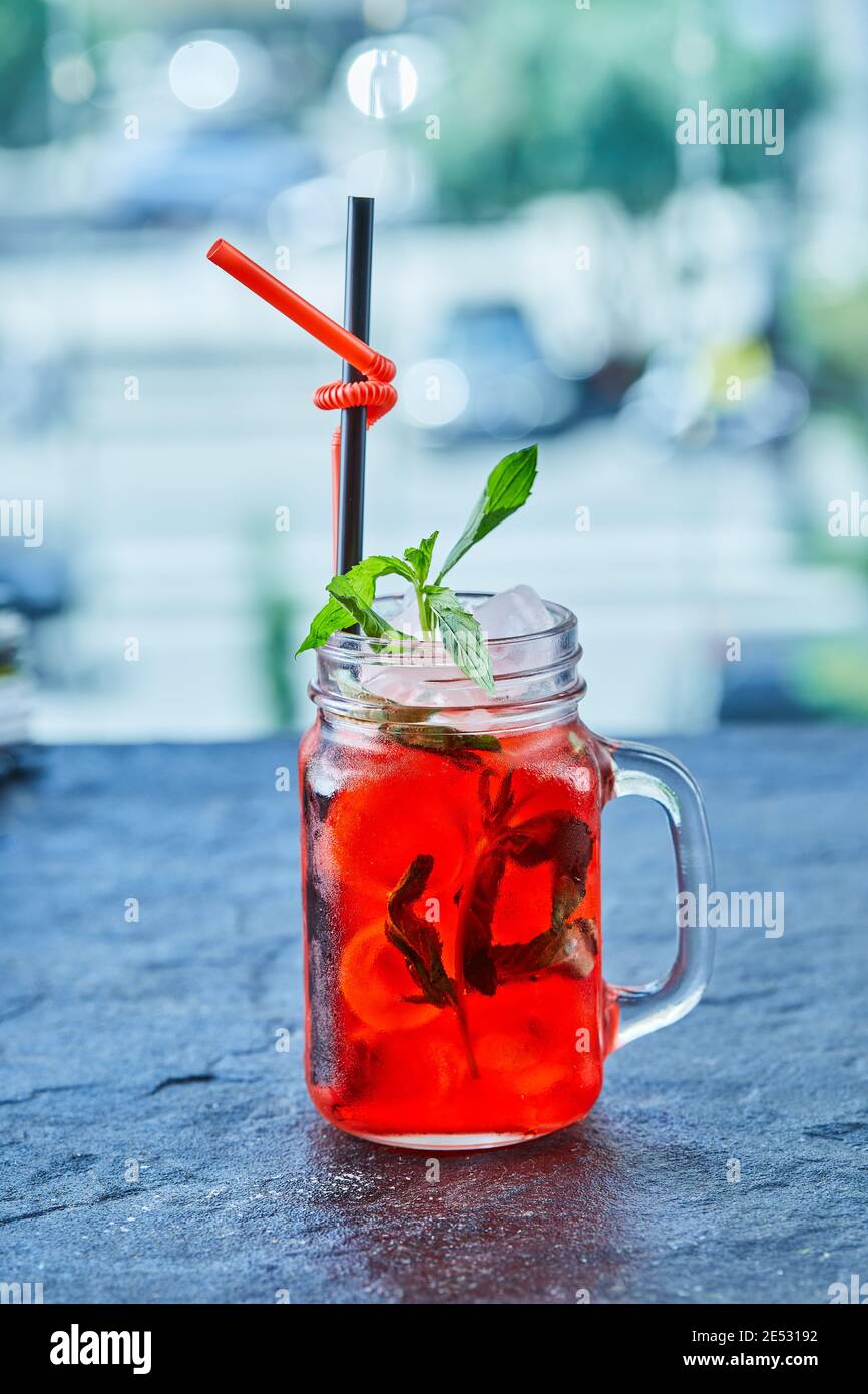 Strawberry lemonade with ice, straw mint in the dark background Stock ...