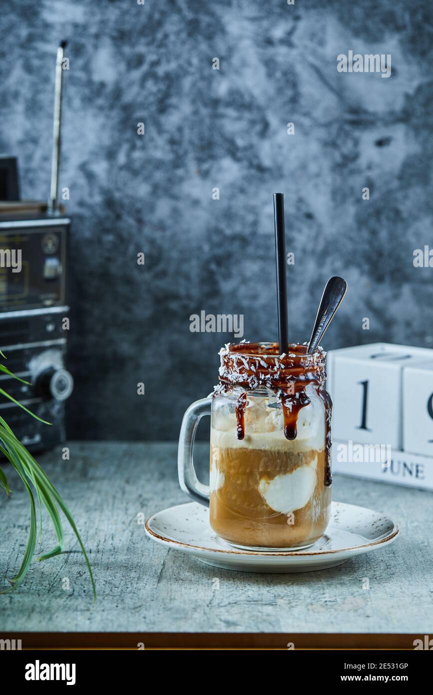 Unfinished milkshake with chocolate on mug with spoon Stock Photo - Alamy